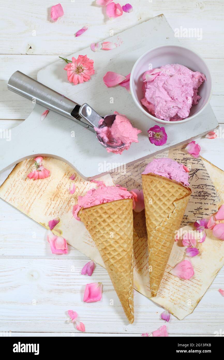 Still life with fruit ice cream and a bouquet of roses on a white ...