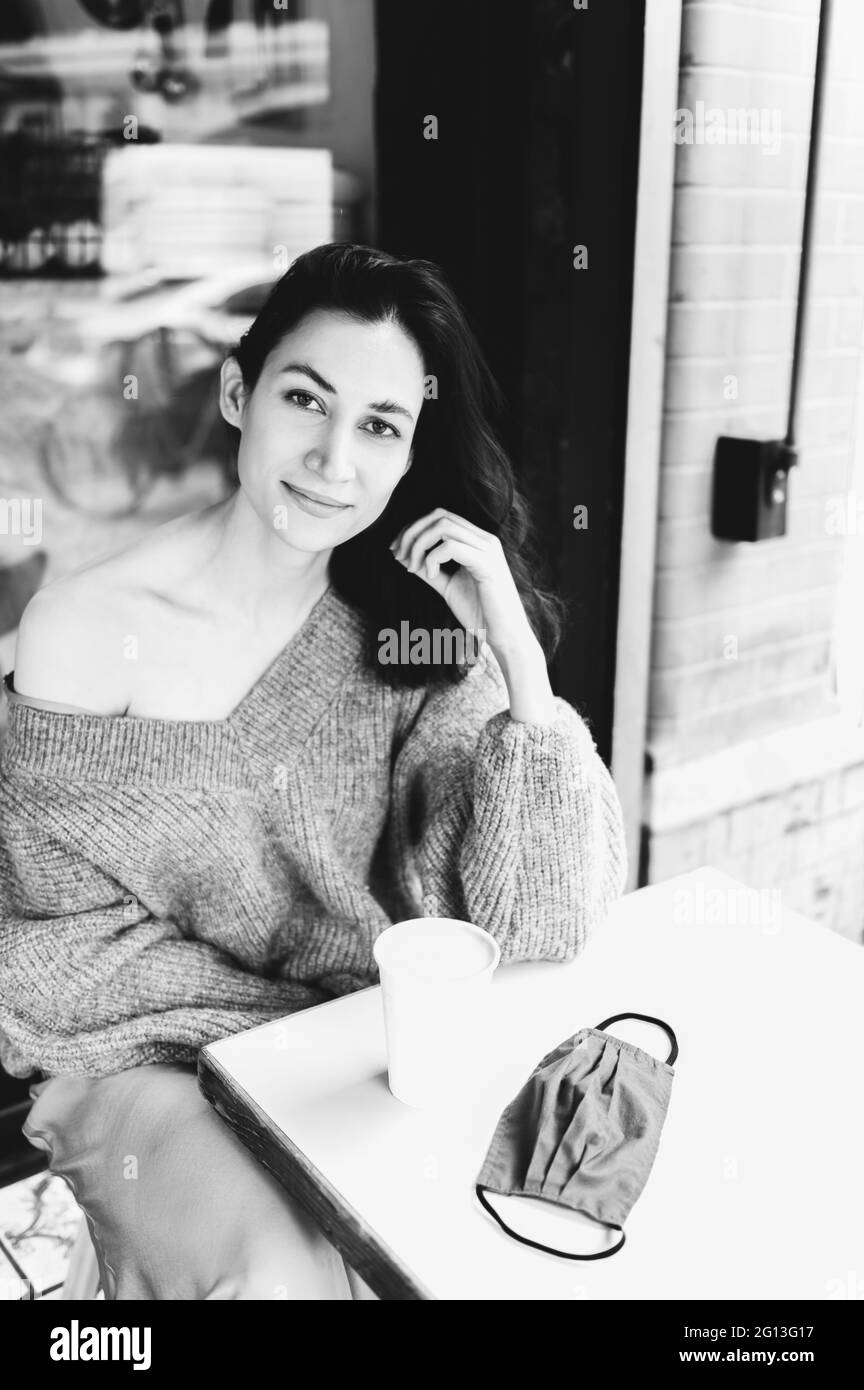 Young lady is drinking coffee at the cafe Stock Photo - Alamy