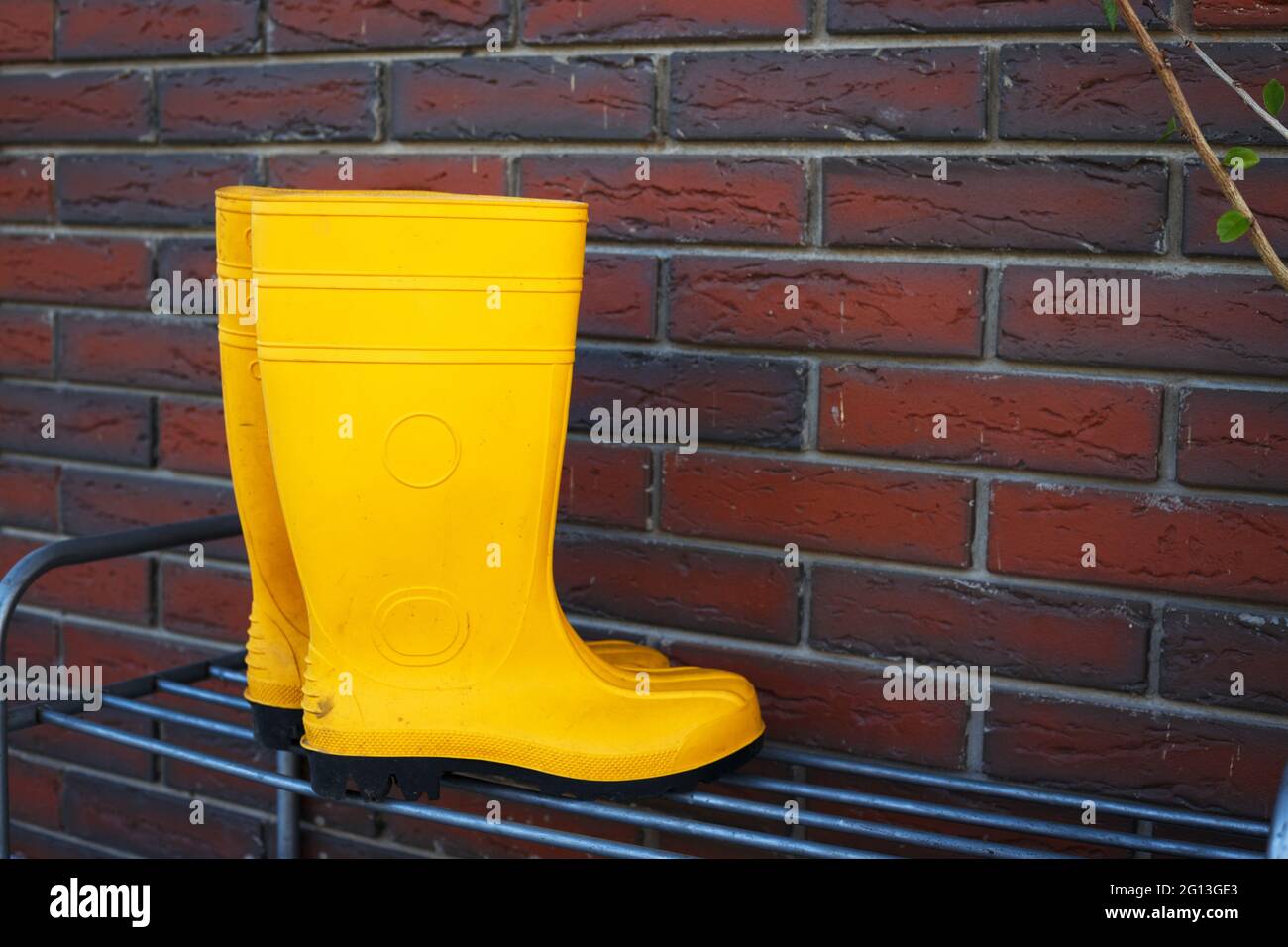 yellow rubber boots near the entrance to the house Stock Photo - Alamy