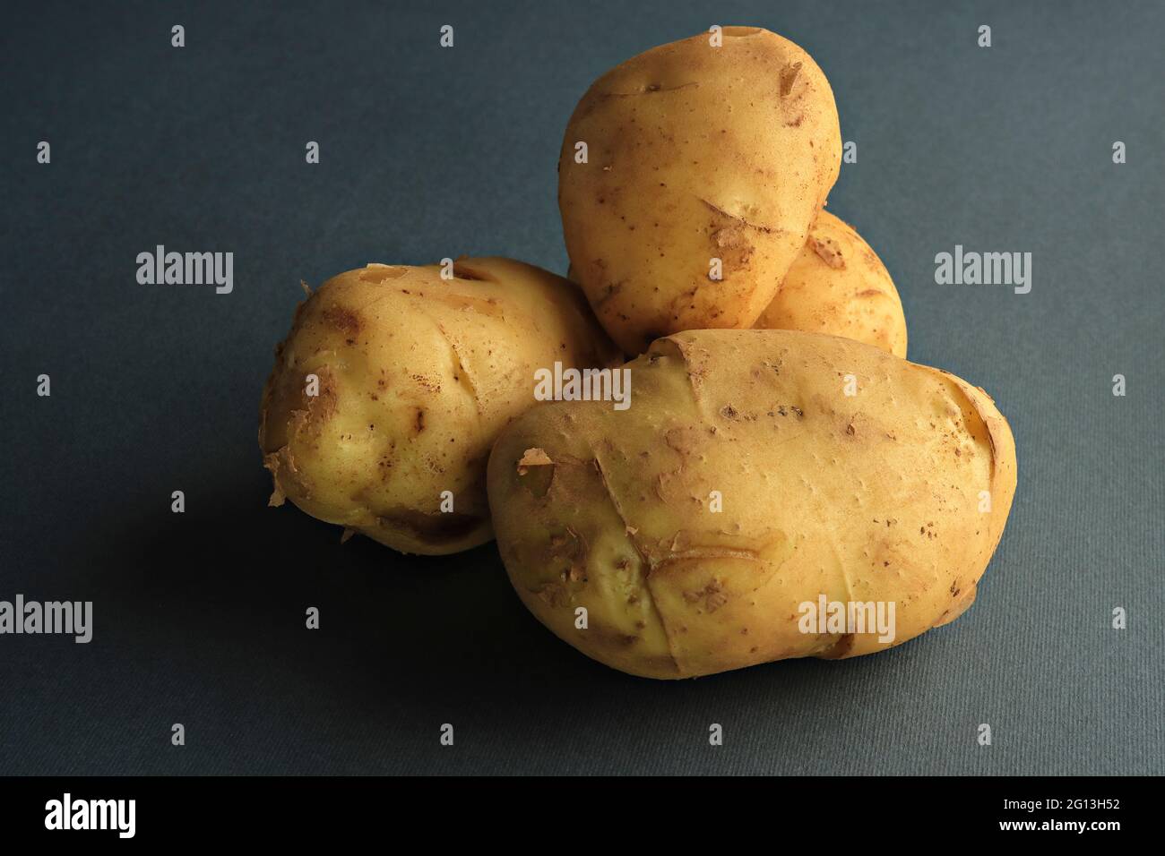 Small White Potatoes on black background Stock Photo - Alamy