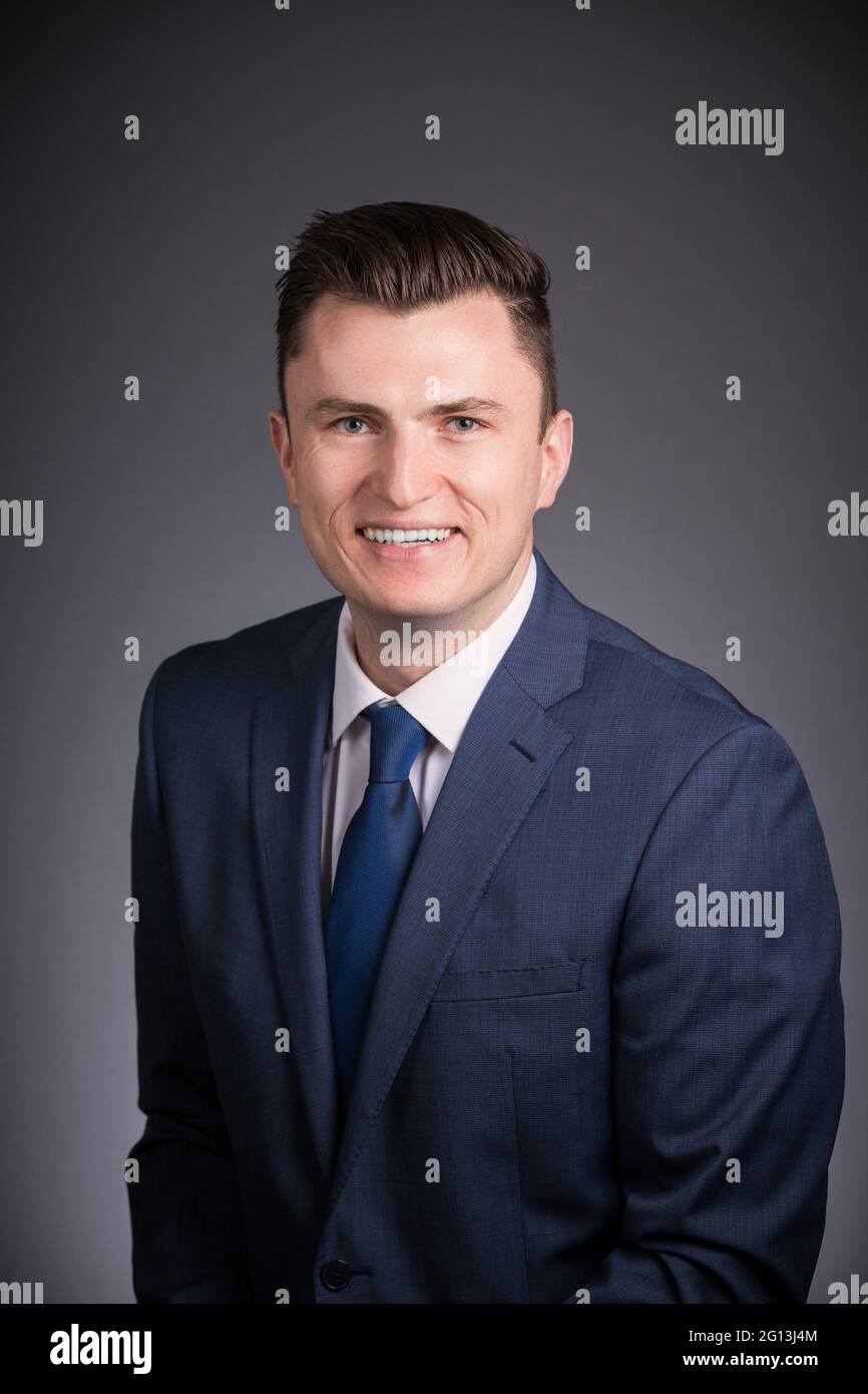 A smiling man, a corporate executive, looks at the camera happily in ...