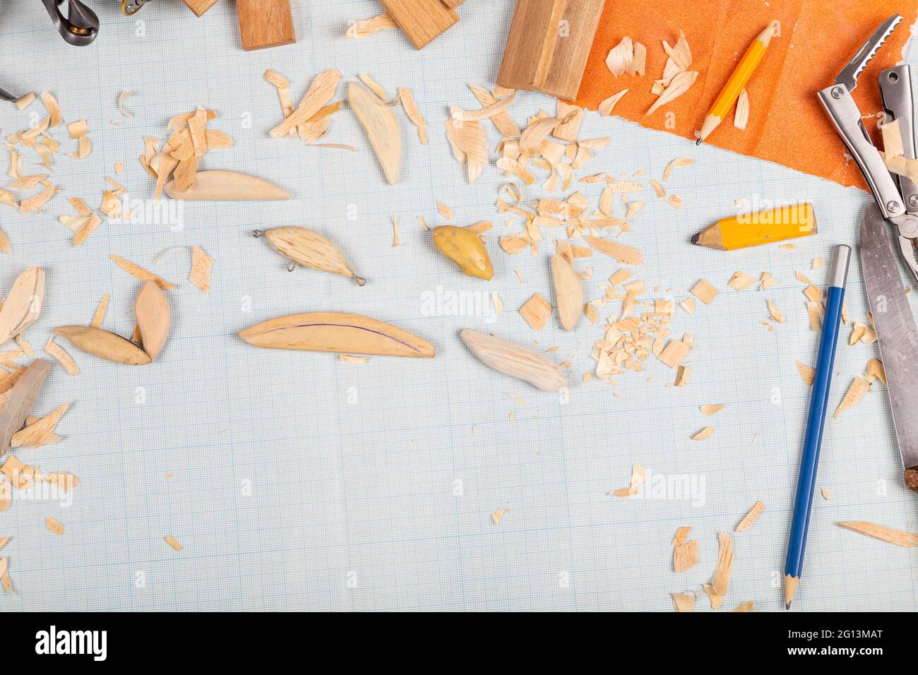 Handmade wooden fishing tacles graph paper background with tools and ...