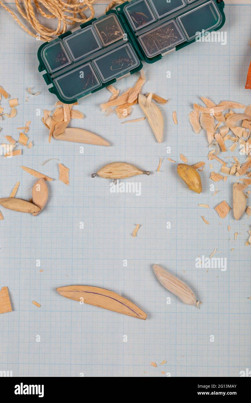 Handmade wooden fishing tacles graph paper background with tools and ...