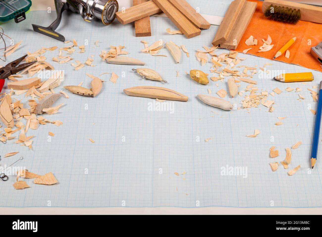 Handmade wooden fishing tacles graph paper background with tools and ...