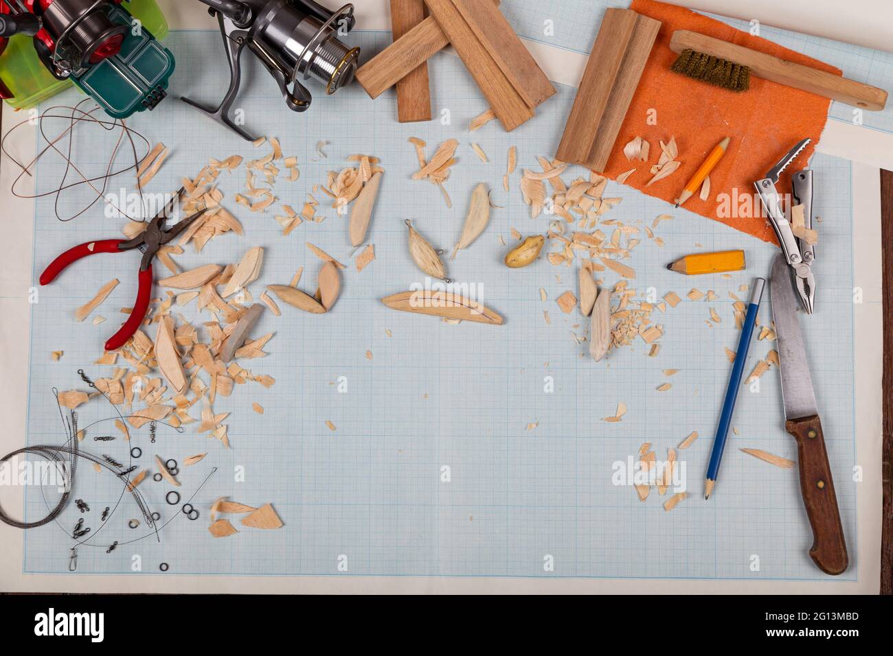 Handmade wooden fishing tacles graph paper background with tools and ...