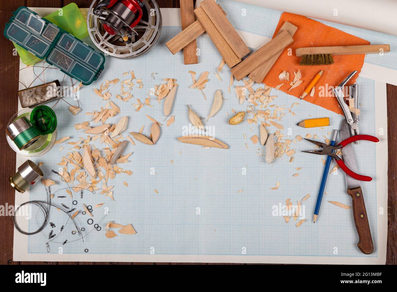 Handmade wooden fishing tacles graph paper background with tools and ...