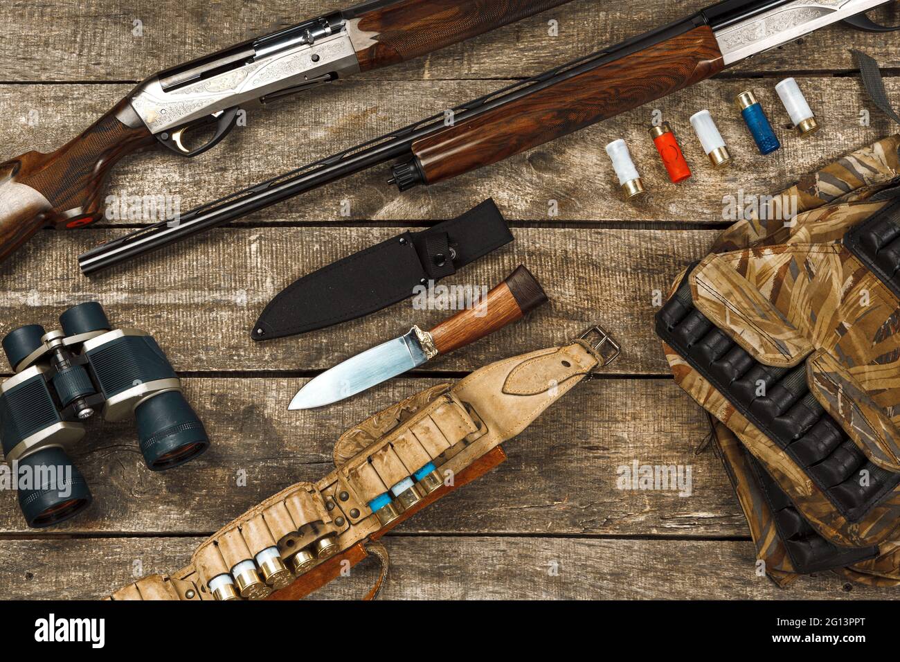 Hunting equipment on old wooden background including rifle, knife ...