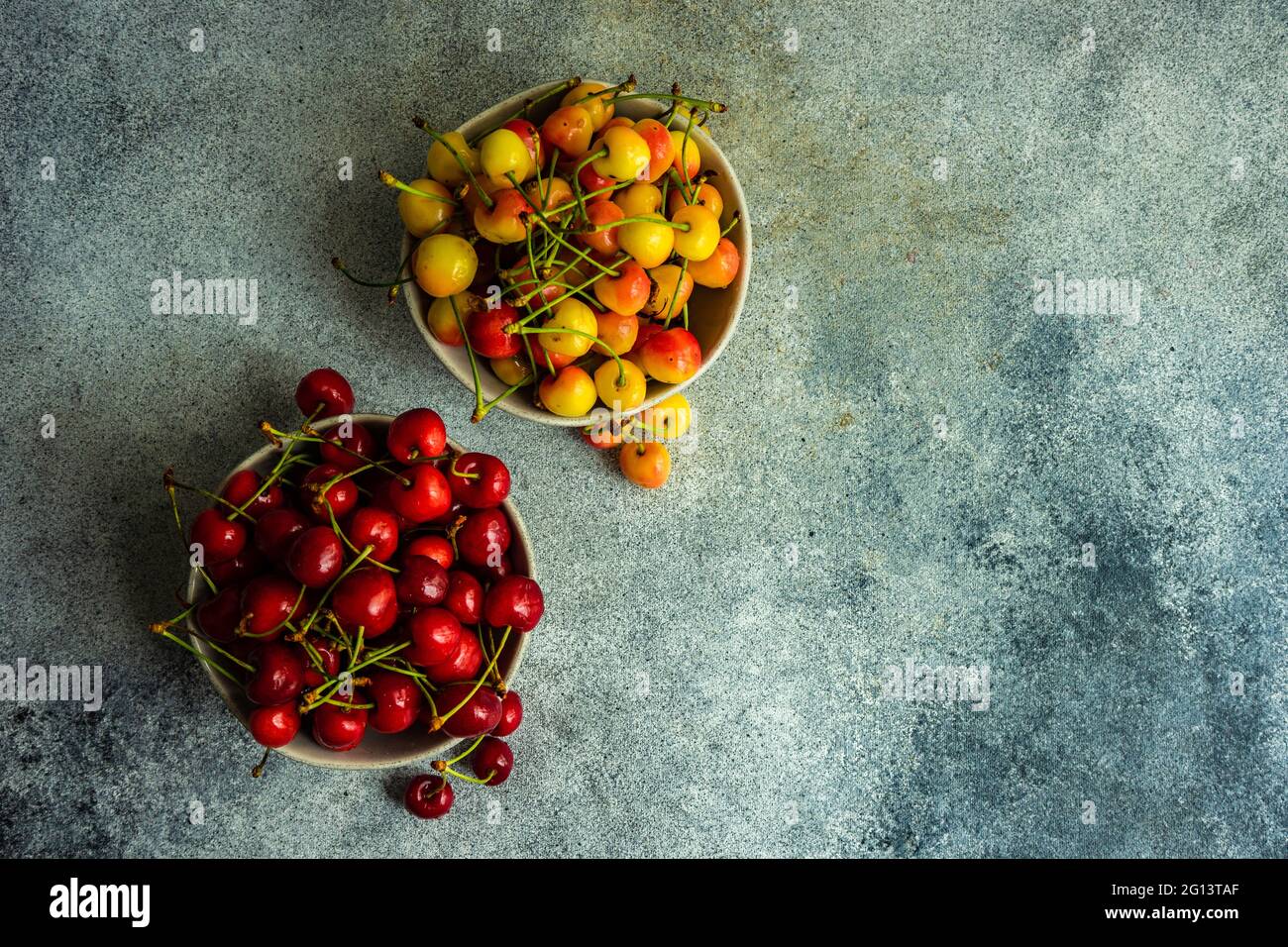 Summer background with ripe sweet cherries in stone bowls Stock Photo ...