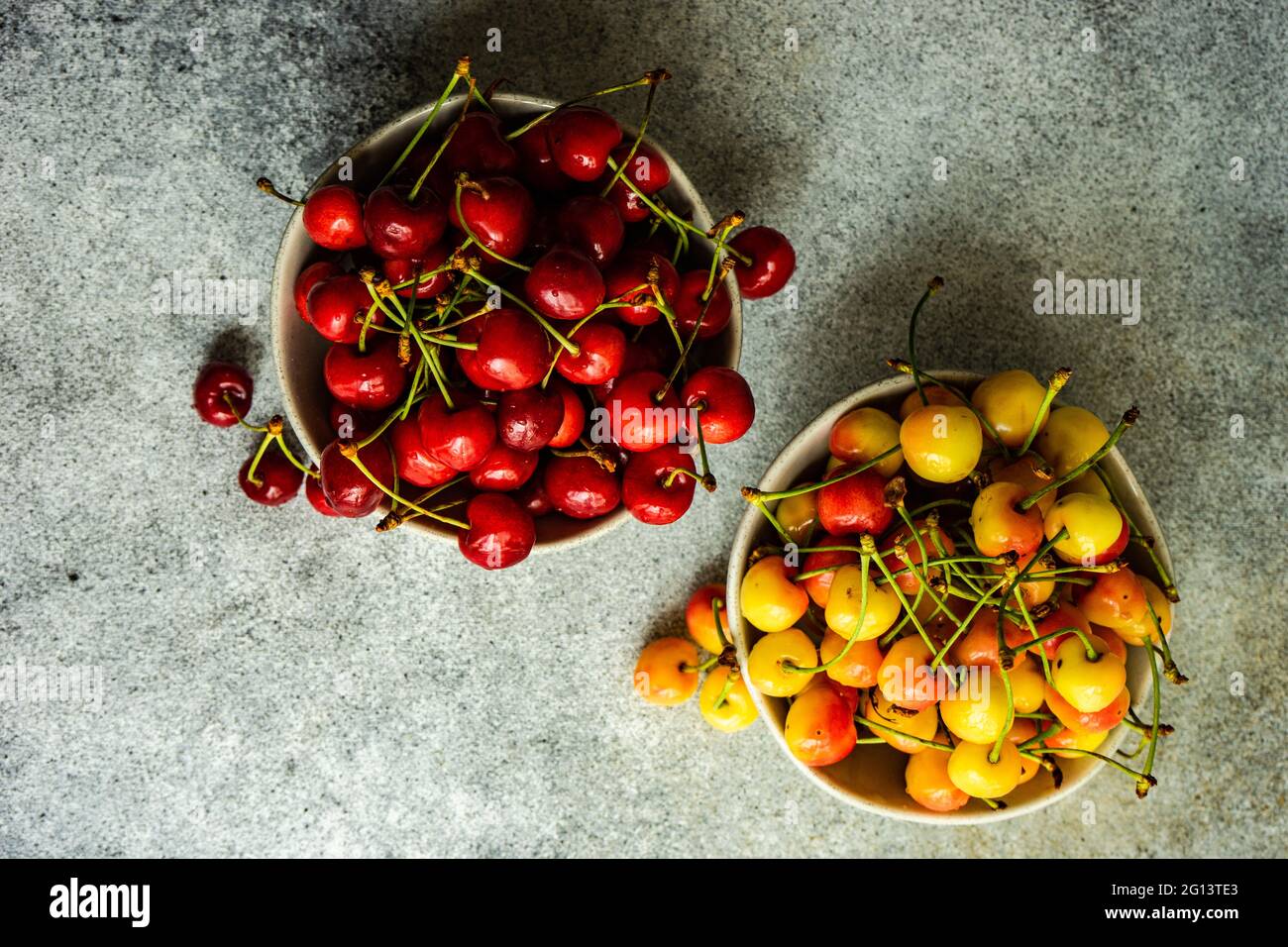 Summer background with ripe sweet cherries in stone bowls Stock Photo ...