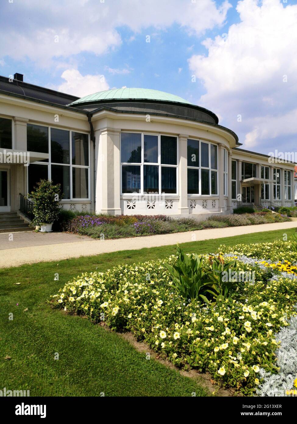 Beautiful view of a building with round bay windows with a garden in ...