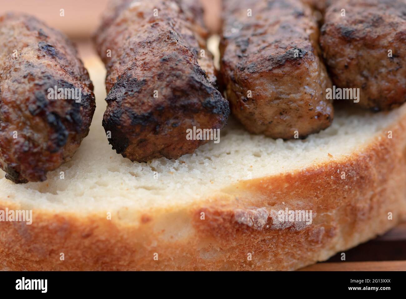 Meat rolls called mici or mititei on a slice of bread isolated Stock ...