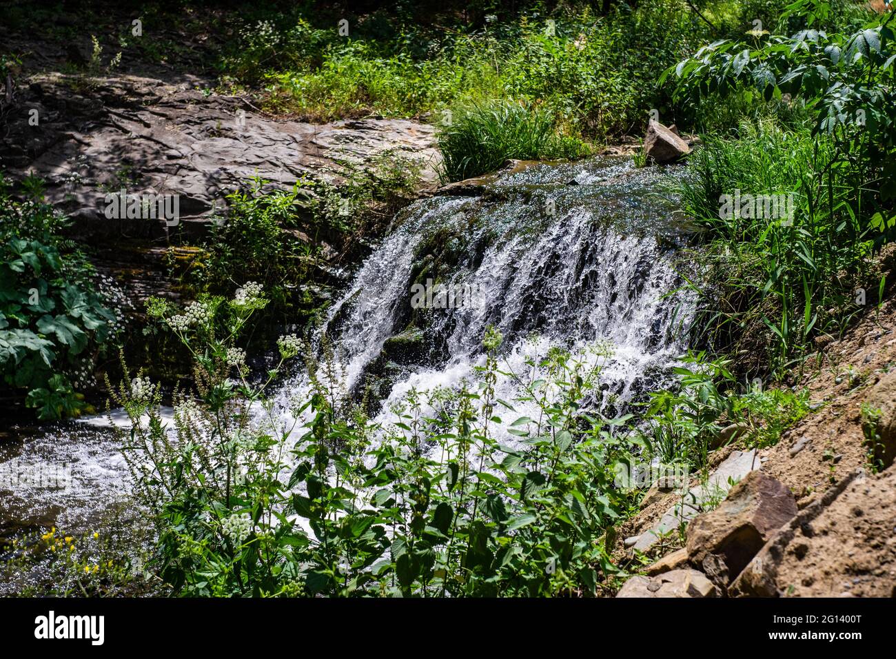 Summer background with waterfall stream among rocks Stock Photo - Alamy
