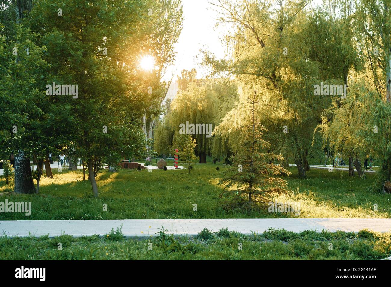 Cement walking path in a beautiful park Stock Photo - Alamy