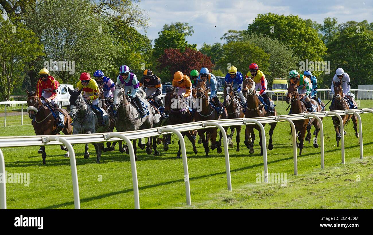 Horses and jockeys galloping down the course from the seven furlong ...