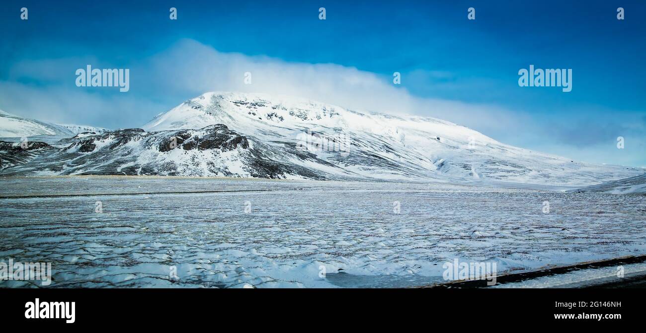 Beautiful winter Icelandic landscape with mountains covered in snow and ...