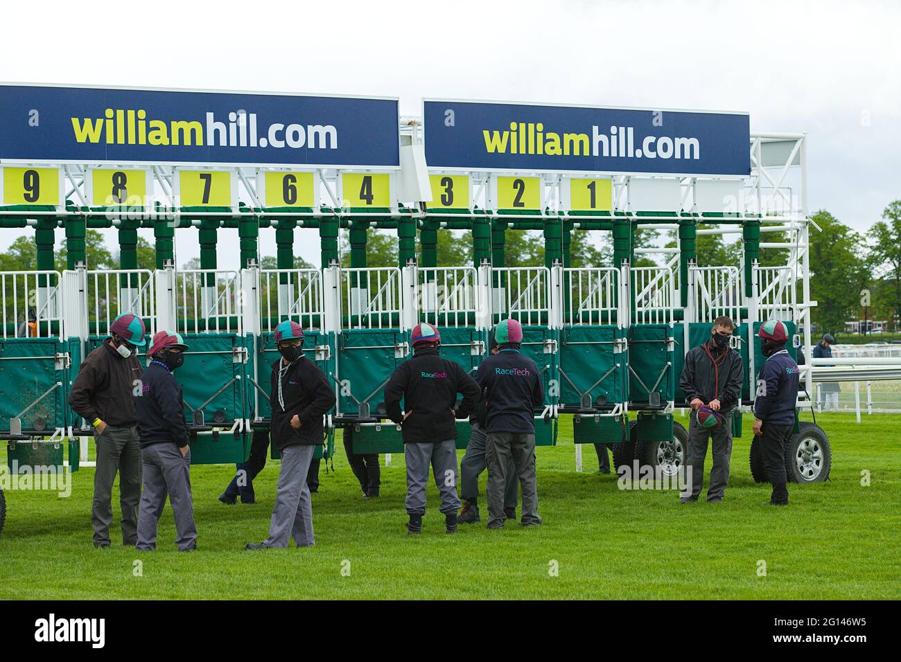 Racecourse staff waiting around at the starting gate for the arrival of ...