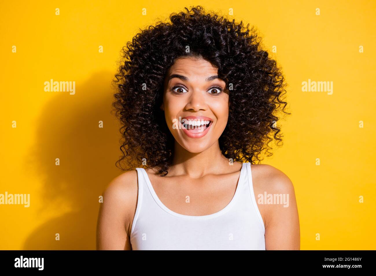Portrait of impressed cheerful dark skin lady open mouth smile look ...