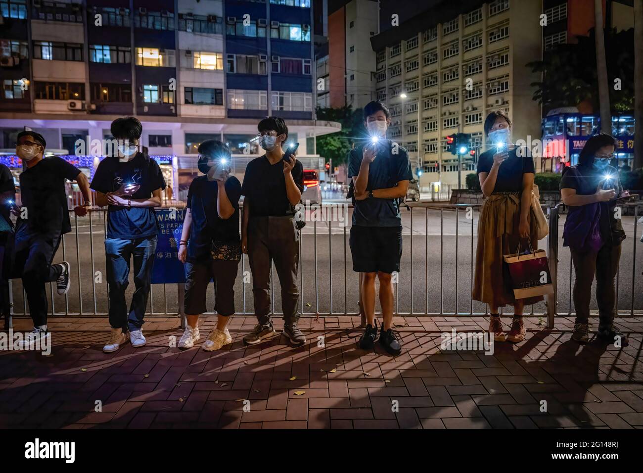 Hong Kong, China. 04th June, 2021. People flashing their mobile phones ...