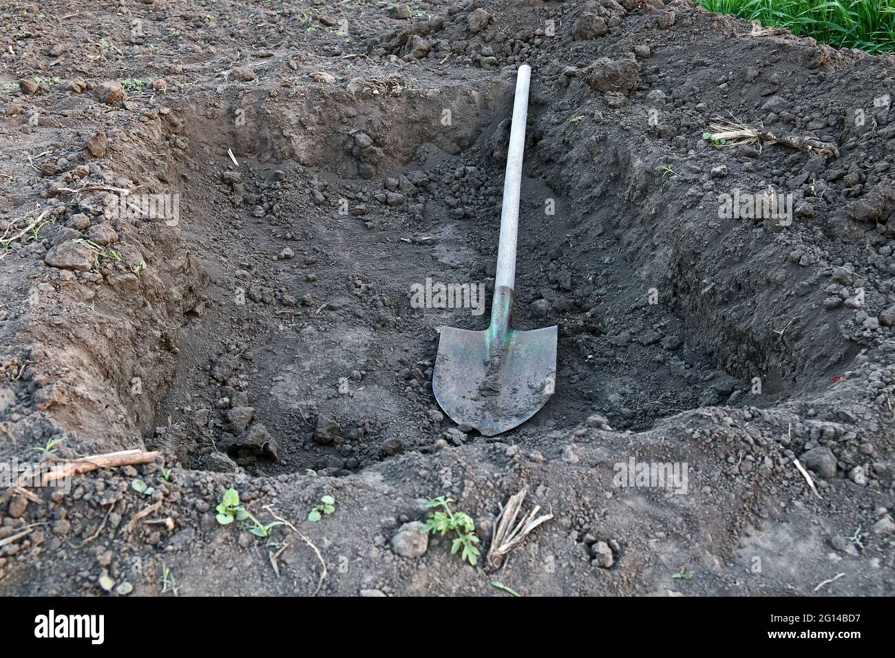 Digging a pit. Pit in the ground. The shovel lays in the pit Stock ...