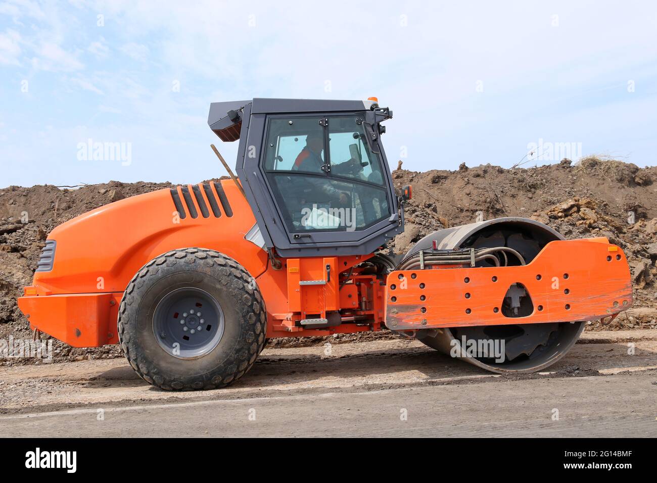 A modern road roller is building a new asphalt road Stock Photo - Alamy