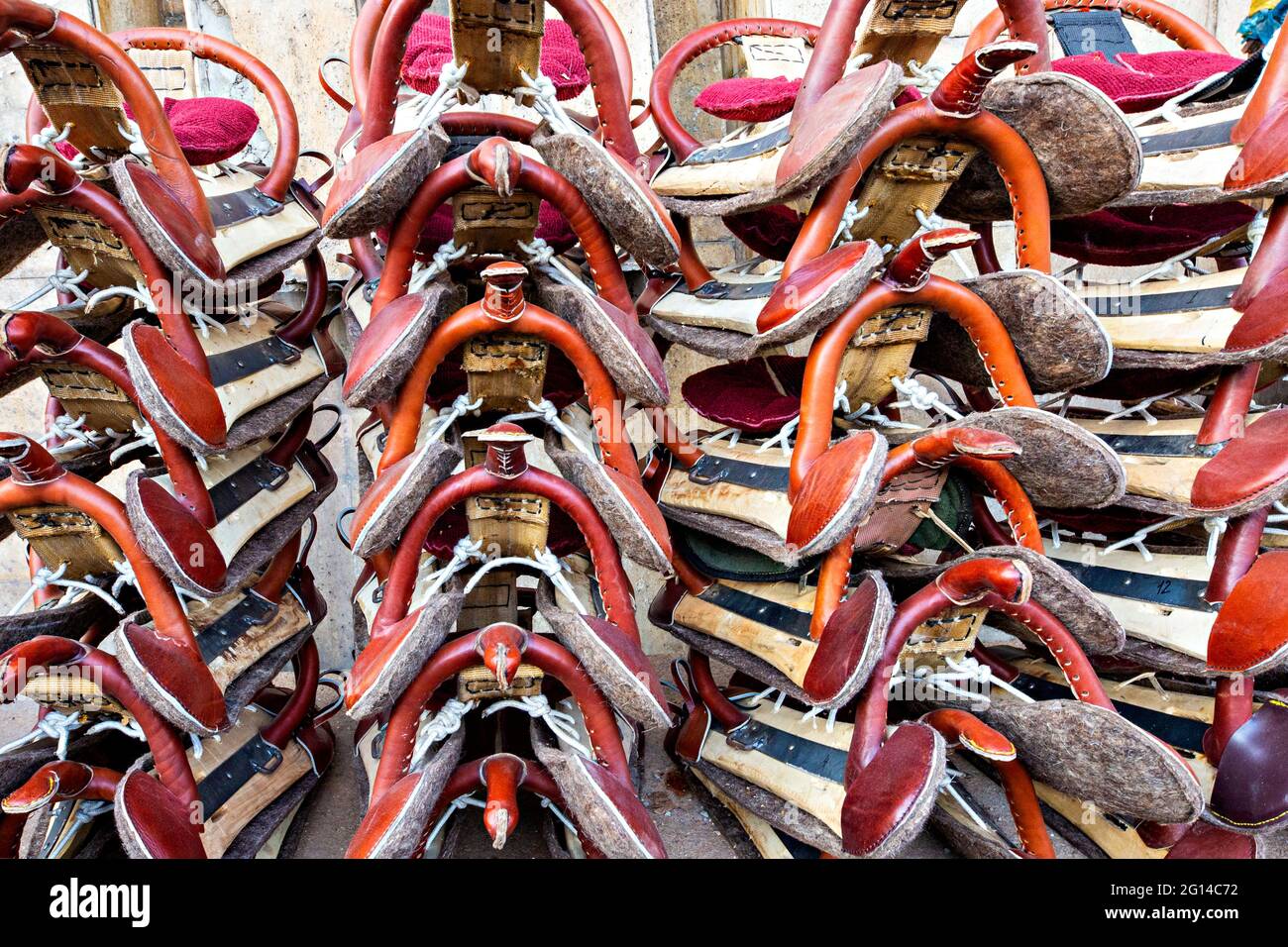 Stacked horse saddles in the market Stock Photo - Alamy