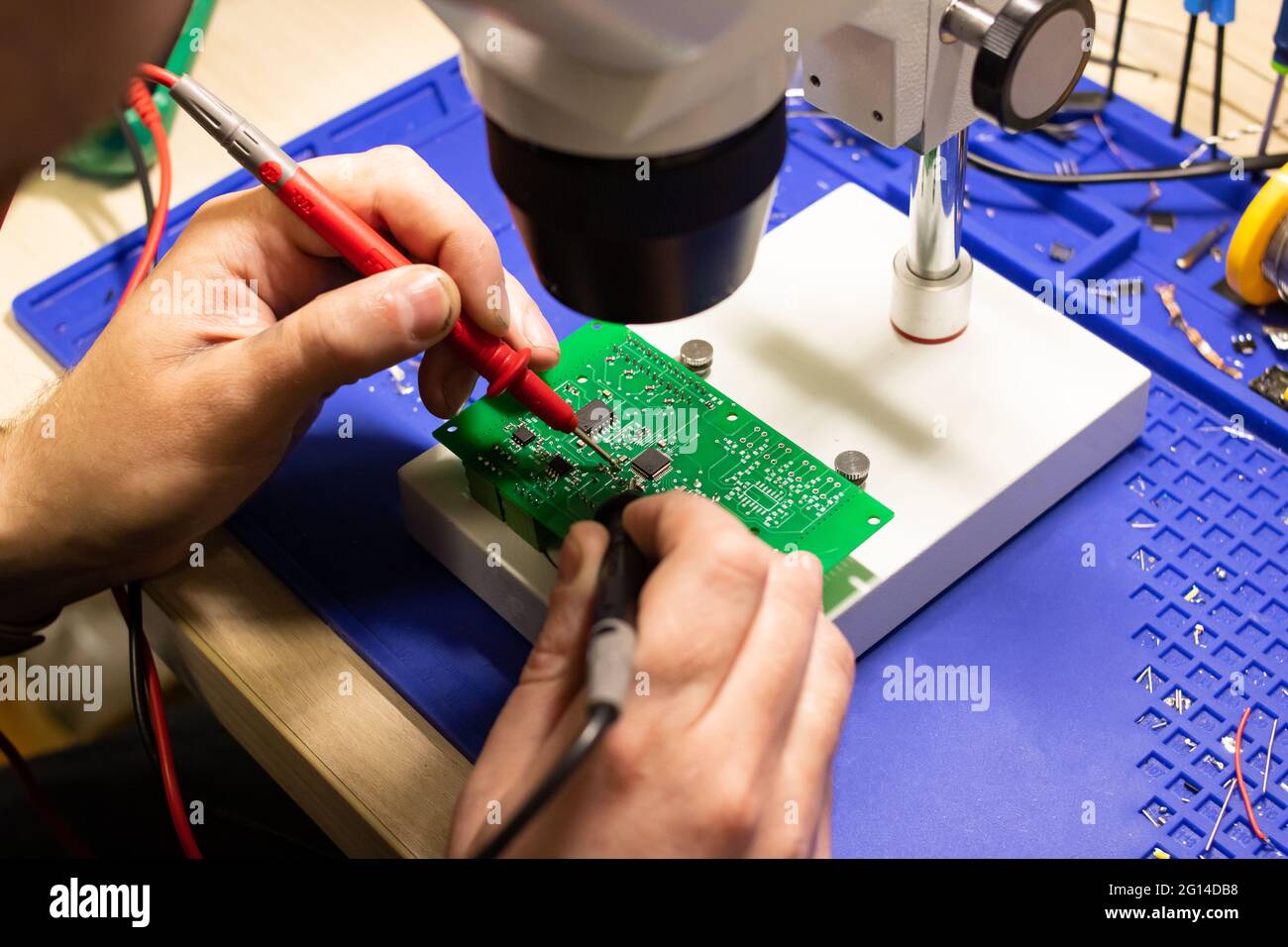Soldering process on a green PCB close up Stock Photo - Alamy