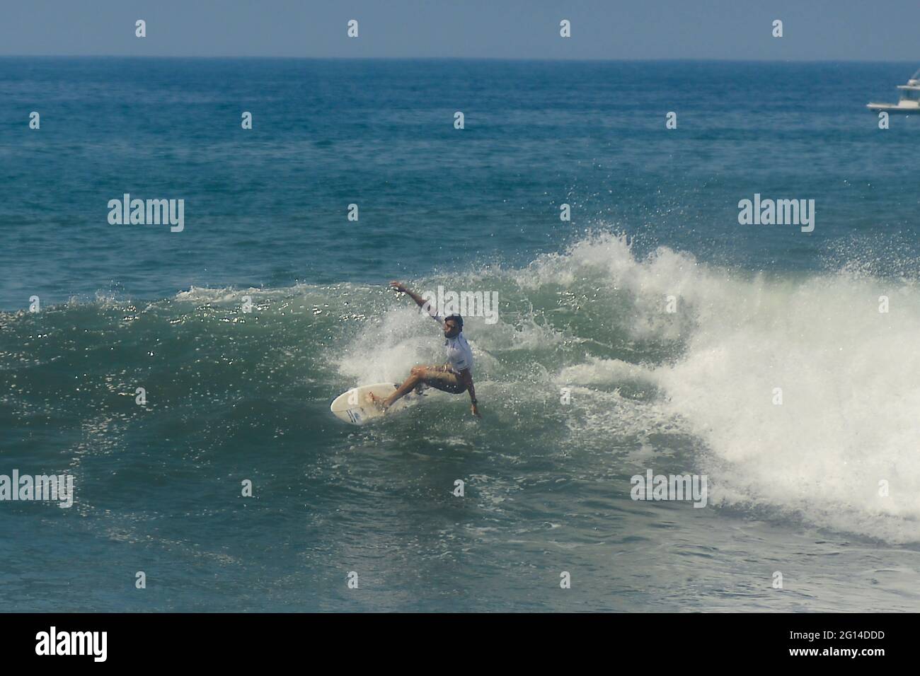 Salvadoran surfer Bryan Perez performs a trick while riding a wave.El ...
