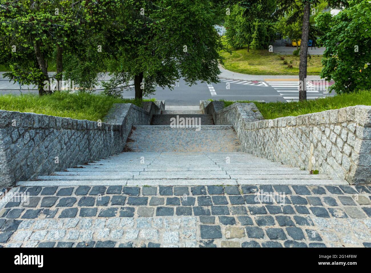 Fence and staircase made of granite stones. A cobbled area with a stone ...