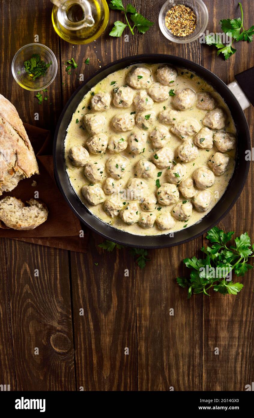 Delicious homemade swedish meatballs with creamy white sauce in frying ...