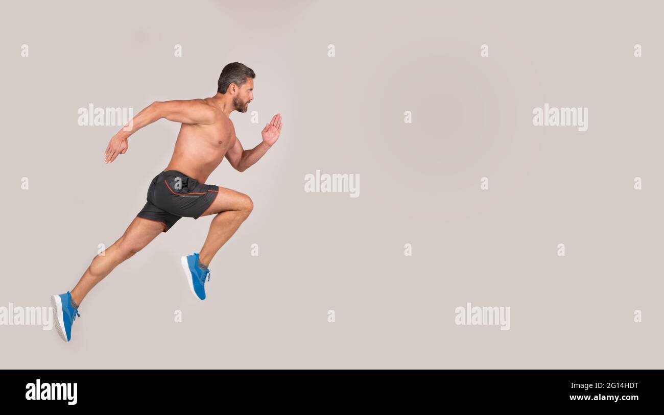 sportsman man runner run to success or jump high on grey background ...