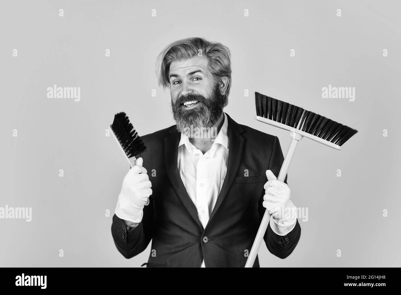 clear business. mature male worker with broom cleaning. Male Janitor ...