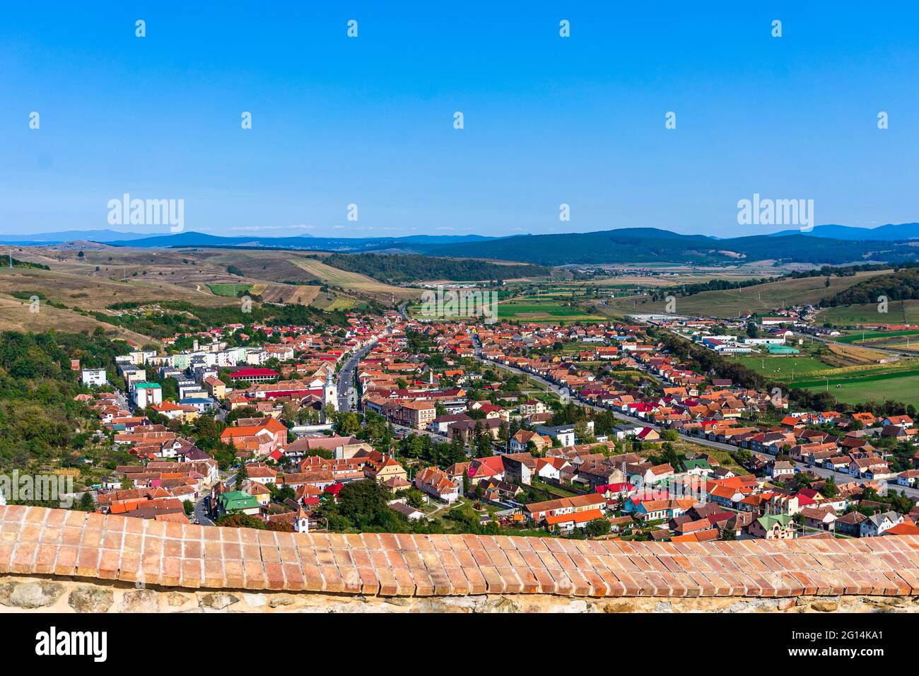 Aerial view of the town center with hills, buildings, streets ...