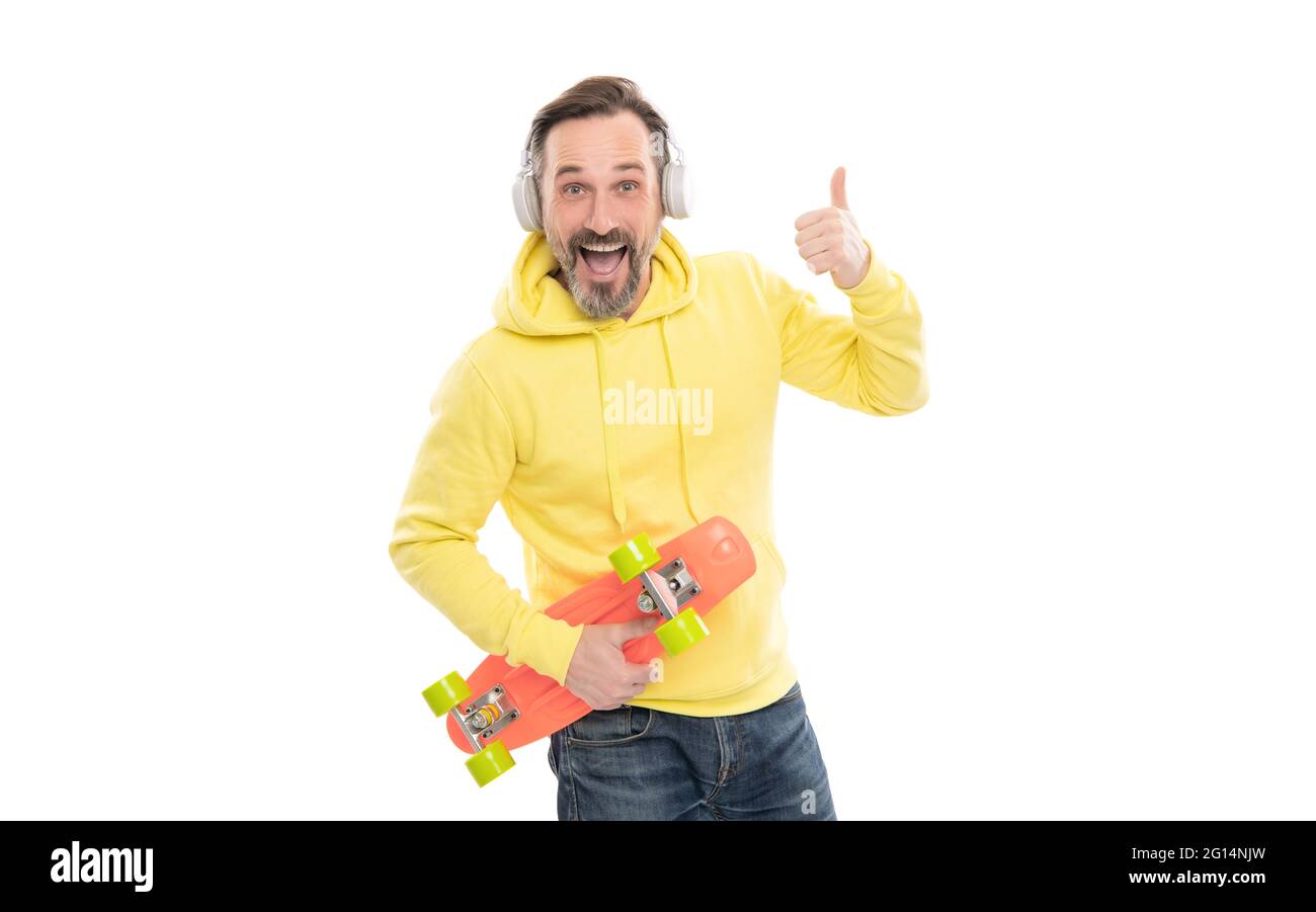 Mature Happy Man With Headphones And Penny Board Senior Guy Listen