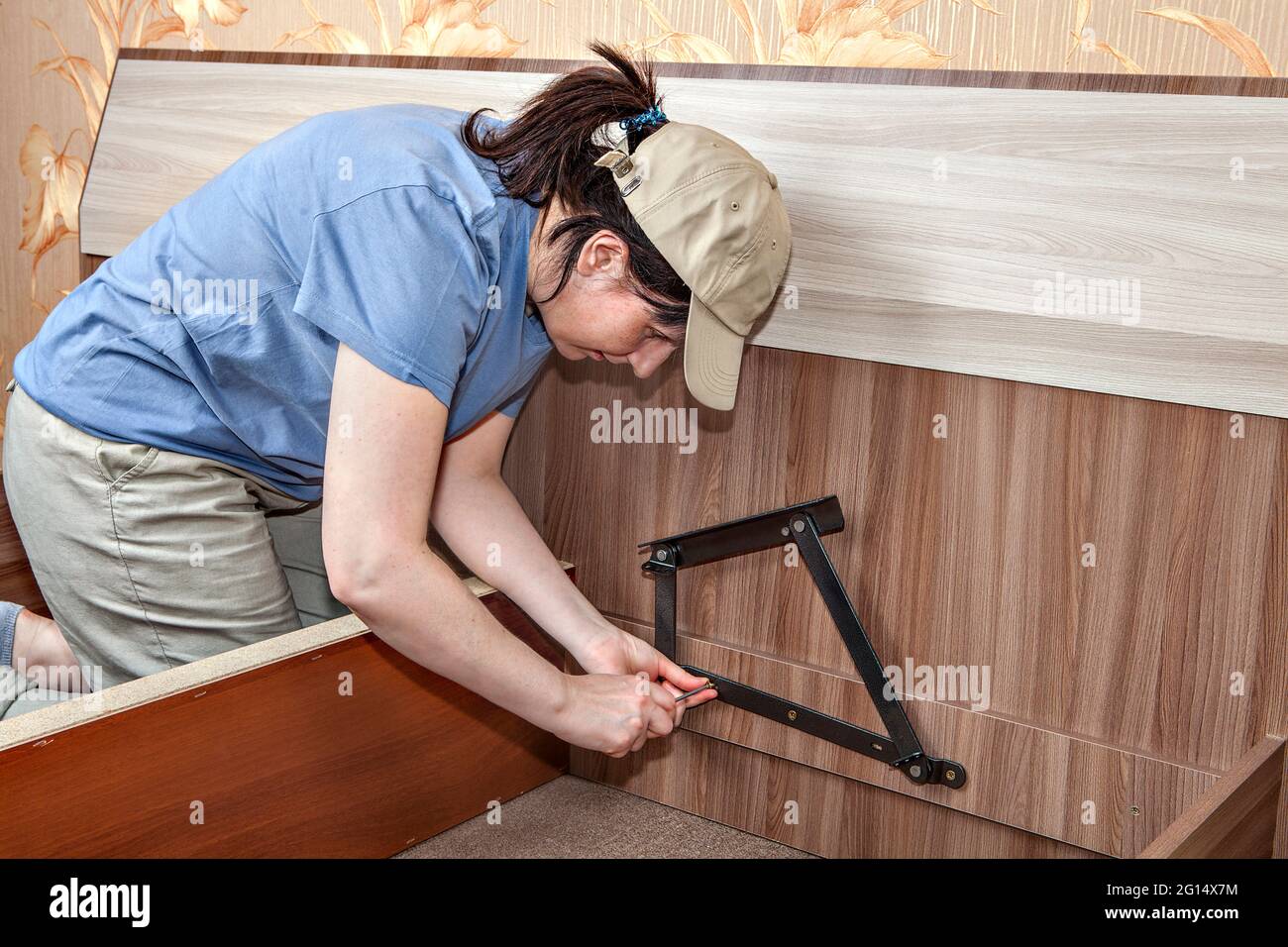 Installing spring loaded lift mechanism on bed with storage compartment ...