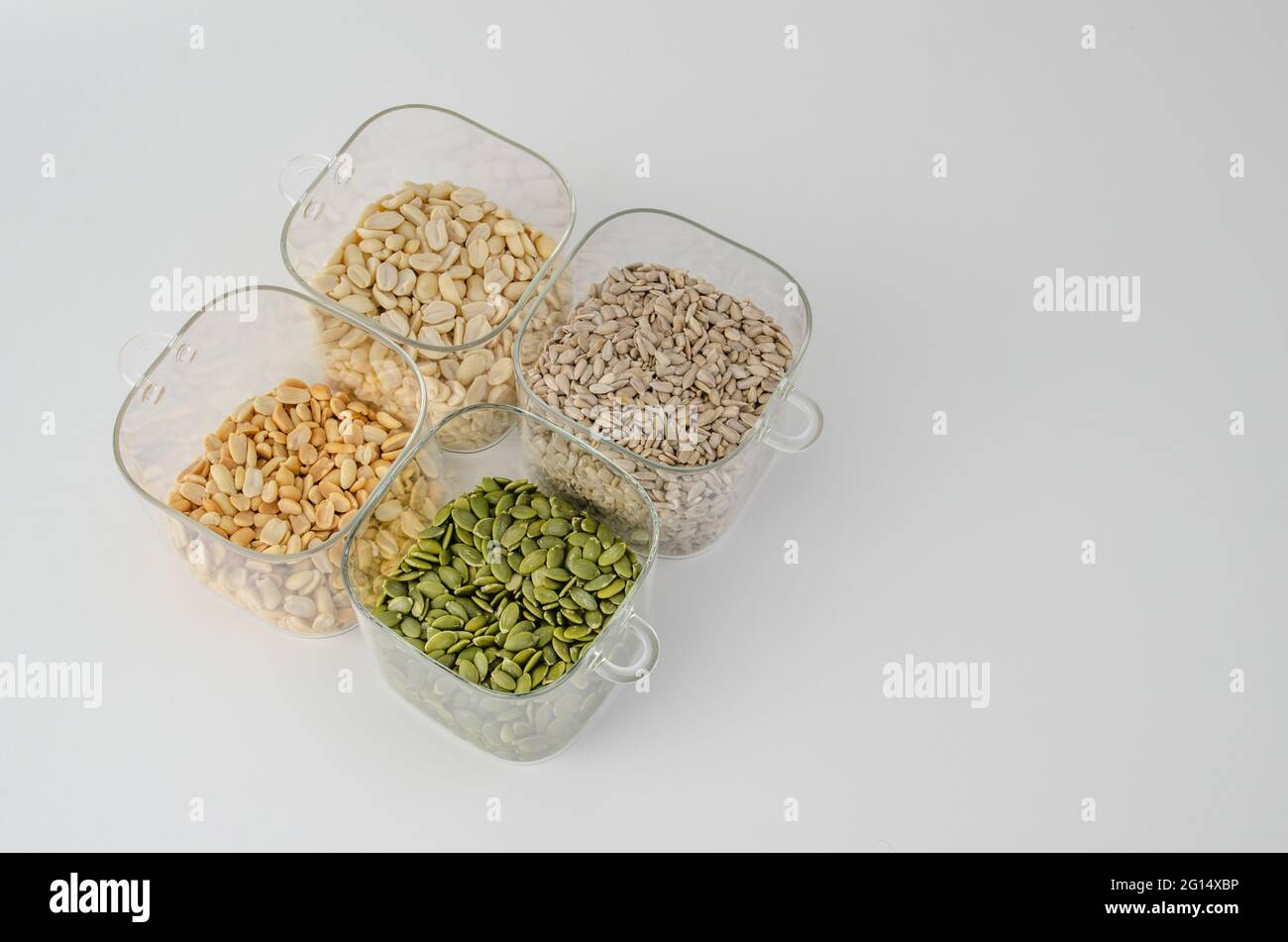 Dry nuts in glass jars, on white background. Food storage. Glass ...