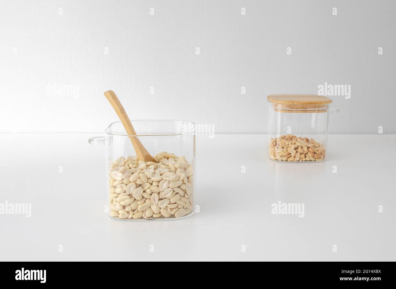 Storing peanuts in glass jars on a white background. Food storage ...