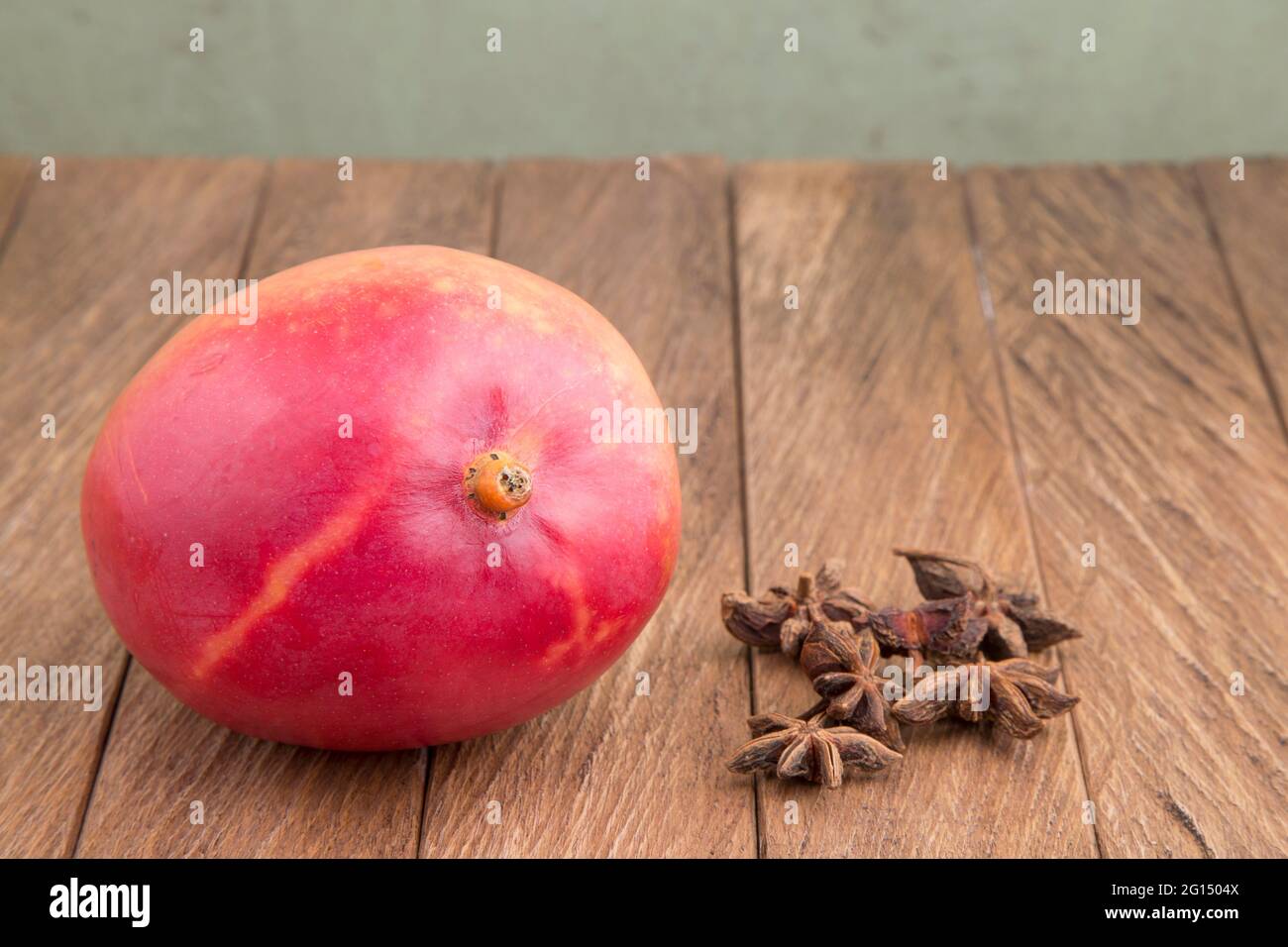 Delicious tommy mango on wooden table - Mangifera indica Stock Photo ...