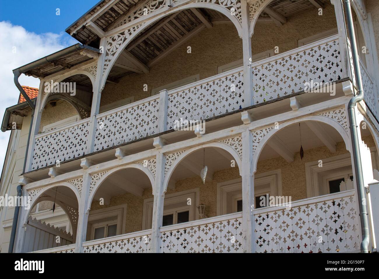 Vertical of a beautiful two-story building with wooden arch balconies ...