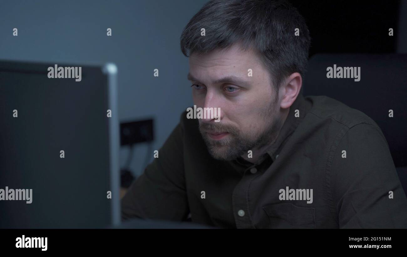 Tired male working on computer. Sad exhausted man at home office ...