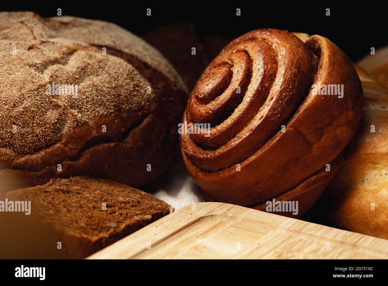 Fresh cinnamon bun roll with sugar powder on wooden board Stock Photo ...