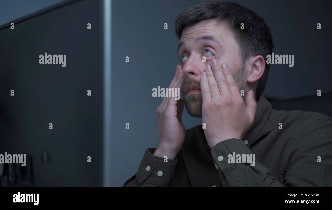 Tired male working on computer. Sad exhausted man at home office ...