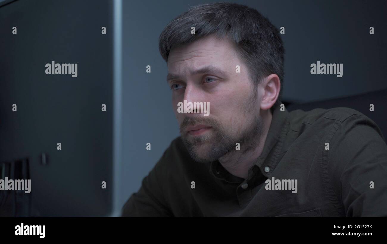 Tired male working on computer. Sad exhausted man at home office ...