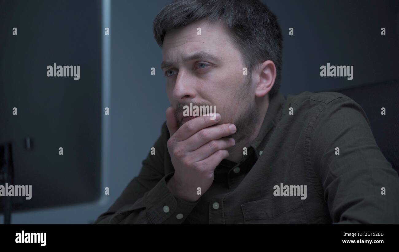 Tired male working on computer. Sad exhausted man at home office ...