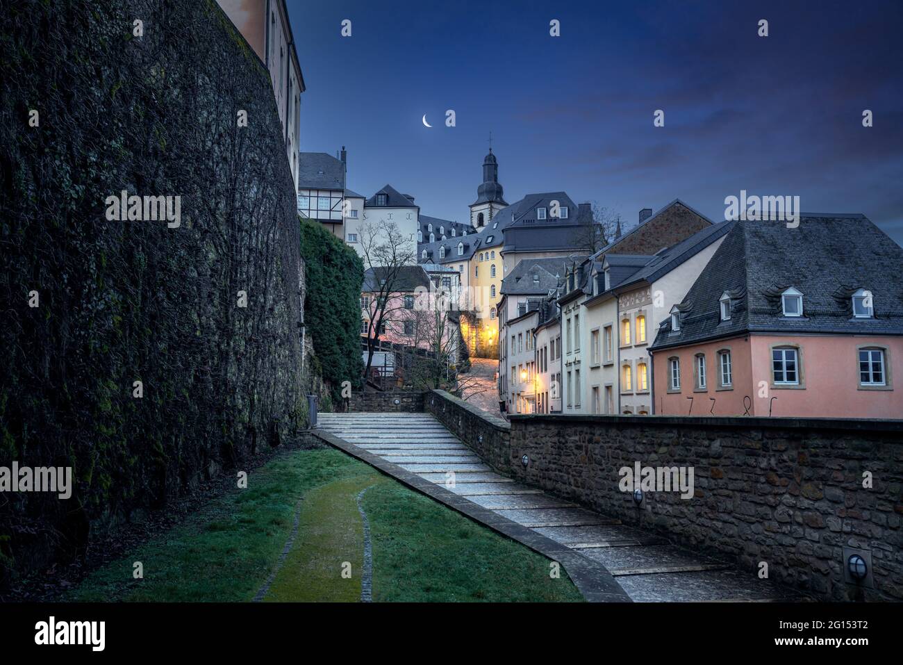Luxembourg city street at night with St Michaels Church on background ...