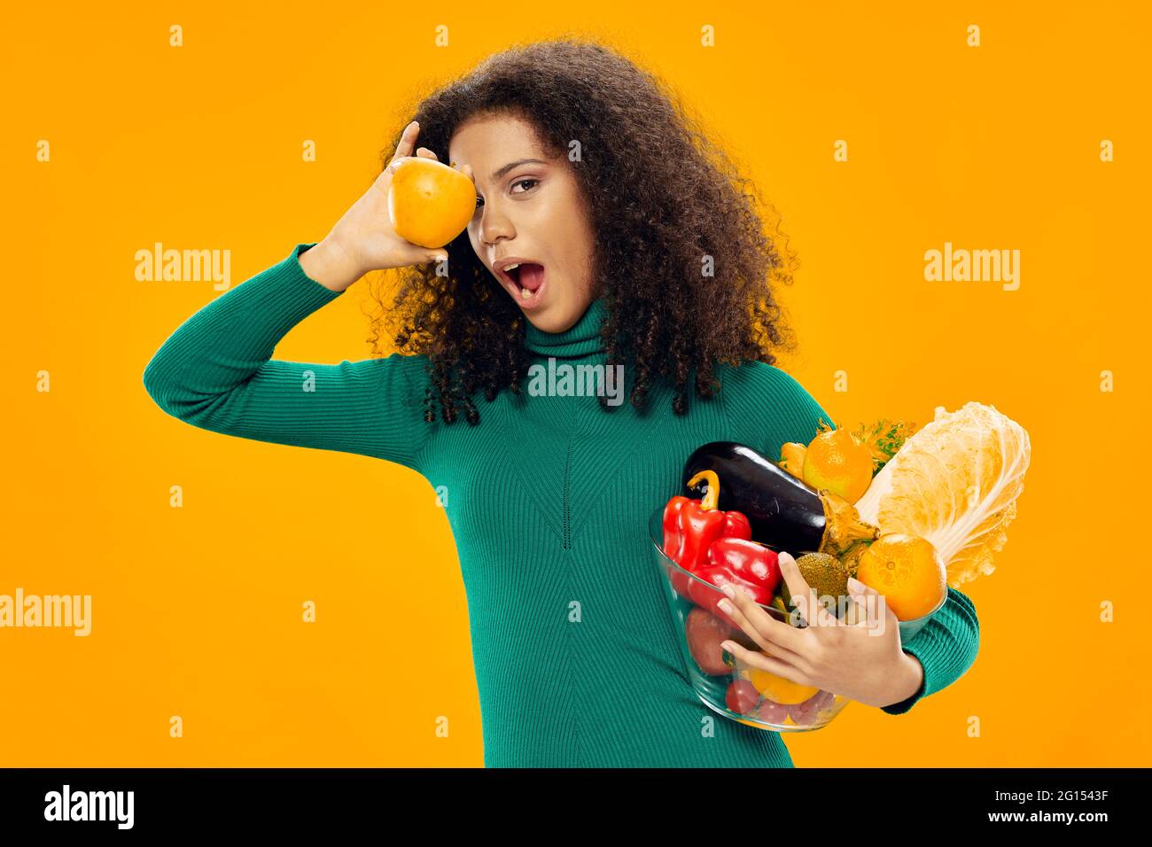 woman with curly hair plate with vegetables healthy food yellow ...