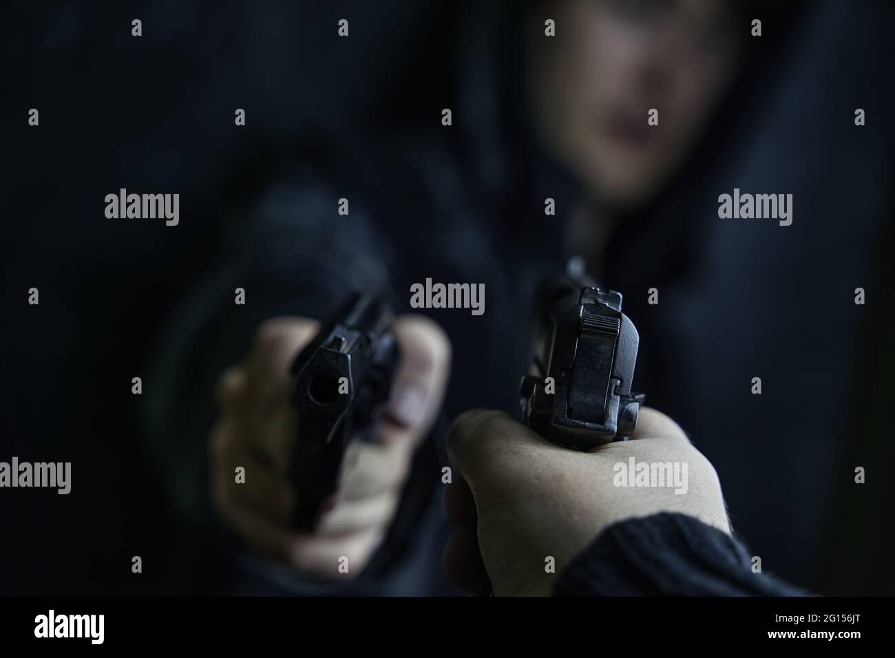 Two shooters threaten each other with weapons. First-person view of ...