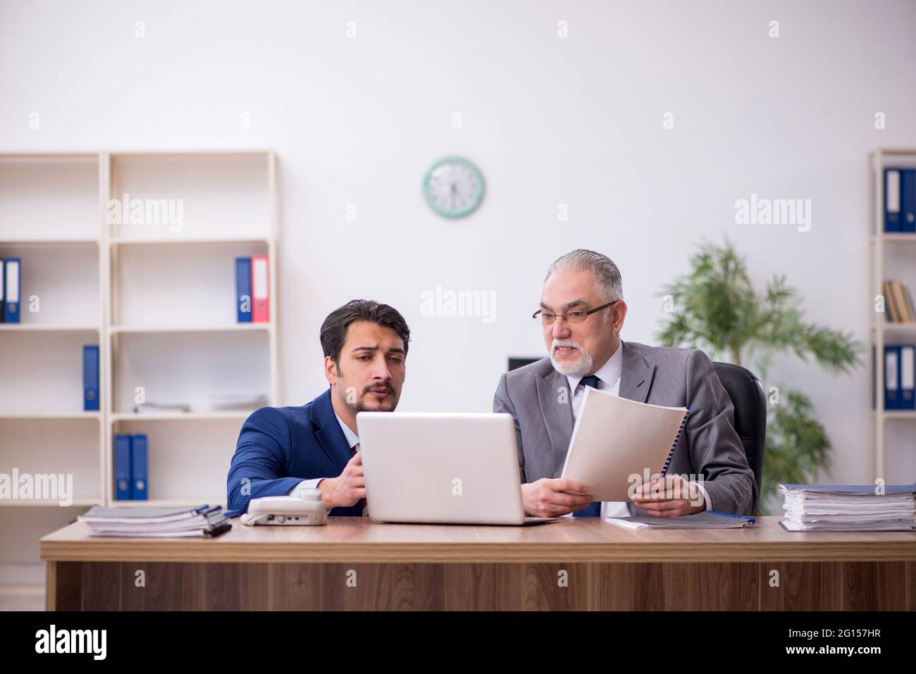 Two employees working in the office Stock Photo - Alamy