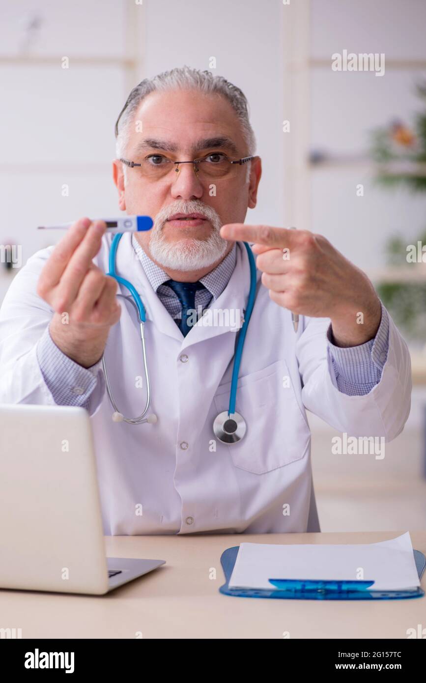 Old doctor working in the clinic Stock Photo - Alamy