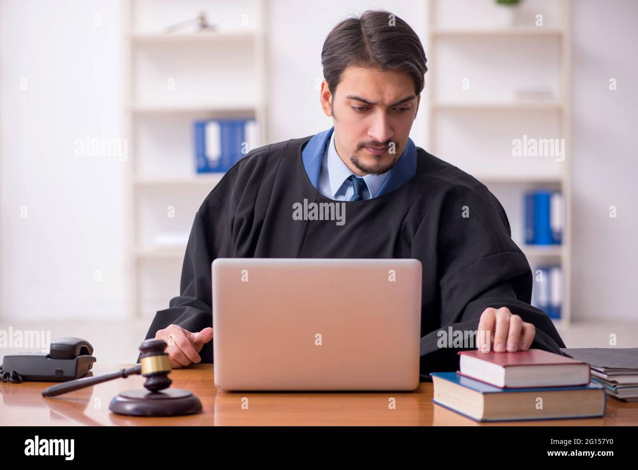 Young judge working in the courtroom Stock Photo - Alamy
