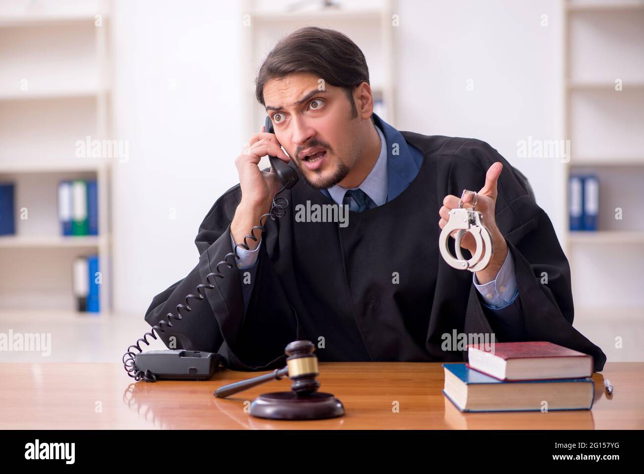 Young judge working in the courtroom Stock Photo - Alamy